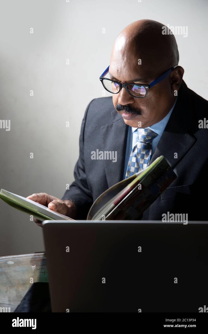 Male manager taking notes in home office. Doing research stock photo ...