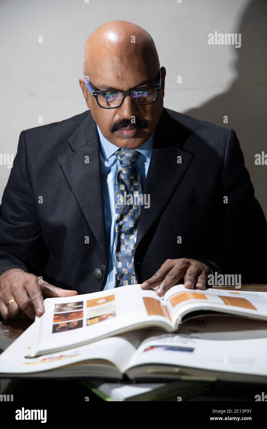 Male manager taking notes in home office. Doing research stock photo ...