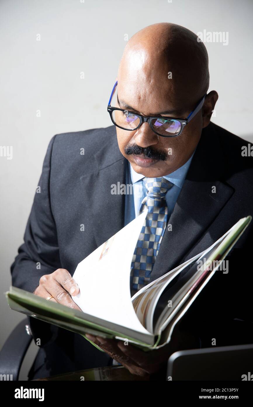 Male manager taking notes in home office. Doing research stock photo ...