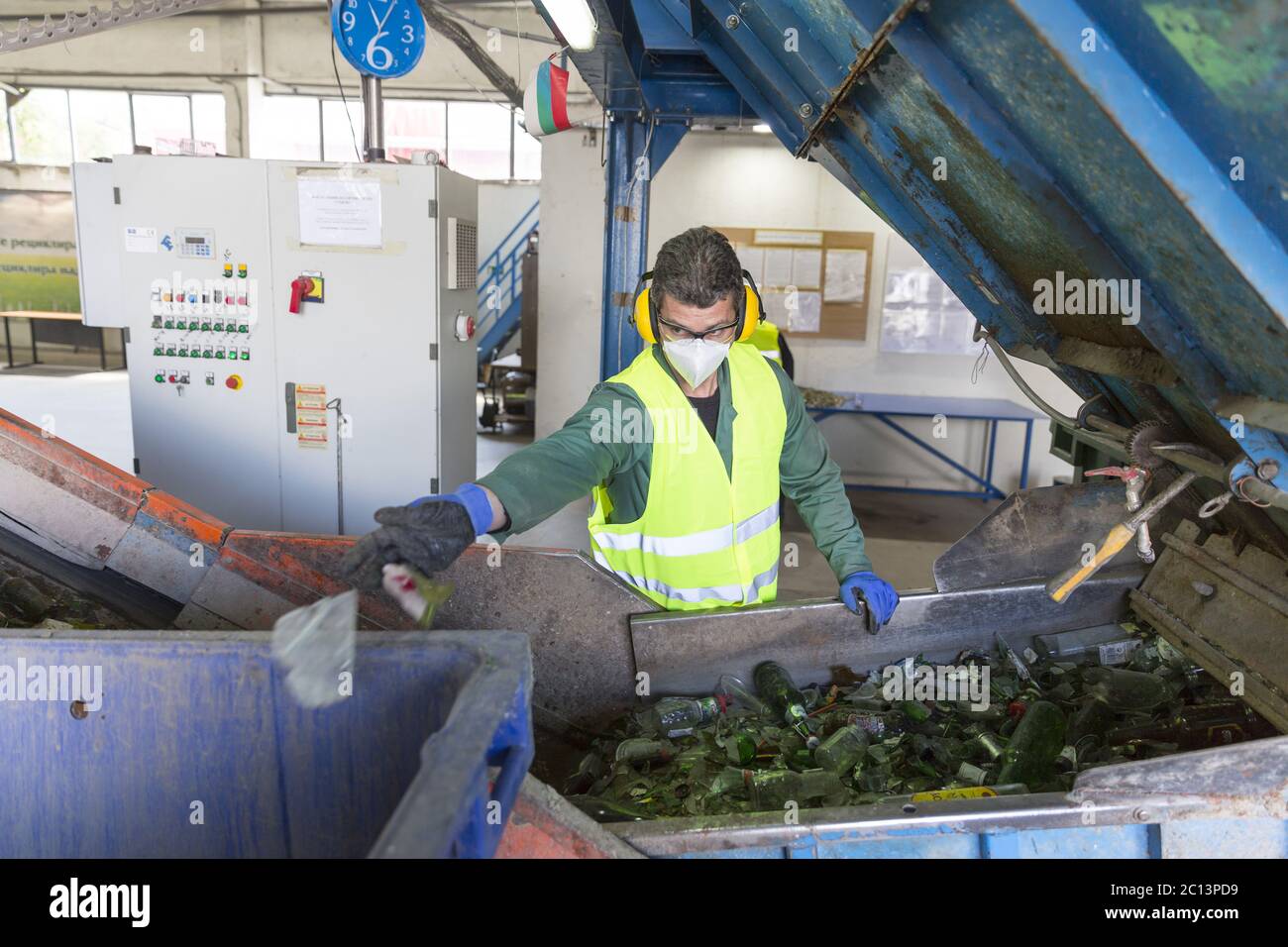 Glass waste worker in recycling facility Stock Photo - Alamy