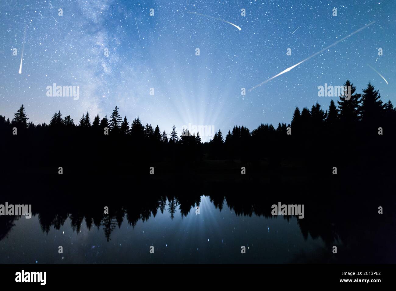 Falling stars Lake pine trees silhouette Milky Way Stock Photo - Alamy