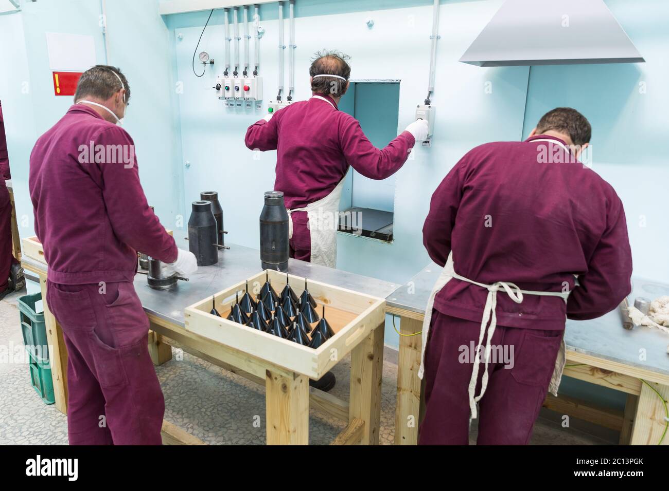 Workers near ammo machine in munition factory Stock Photo - Alamy