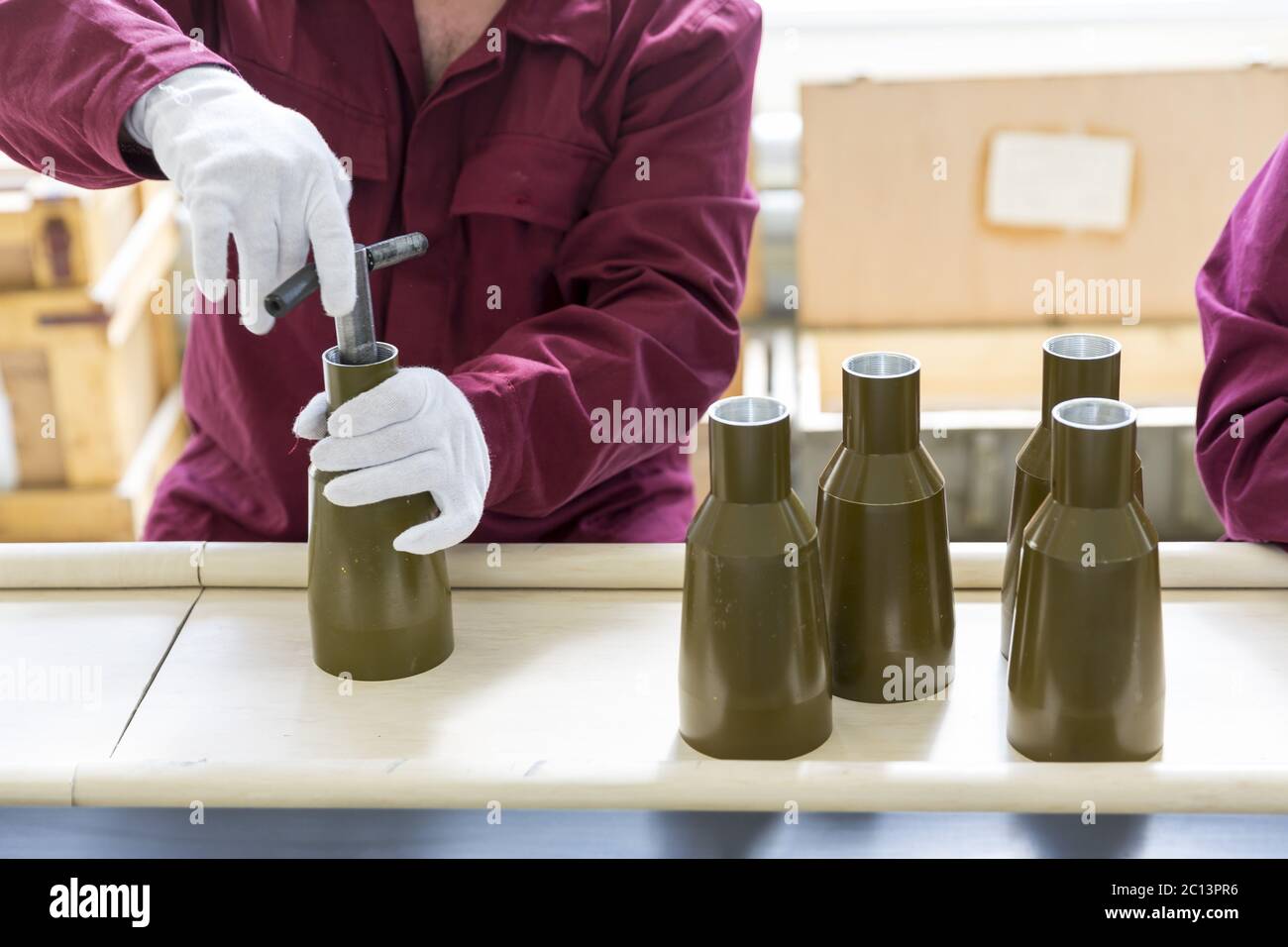 Workers at an assembly line in munition factory Stock Photo - Alamy