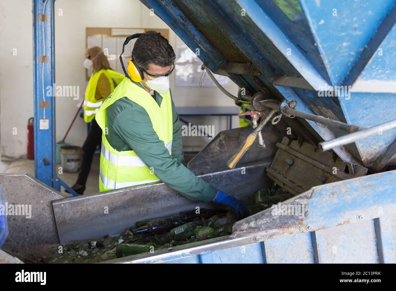 Glass waste worker in recycling facility Stock Photo - Alamy