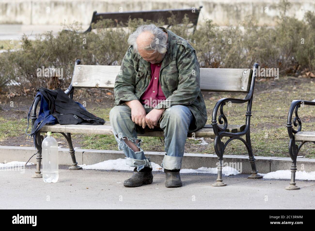 Homeless man sleeping on a bench Stock Photo - Alamy