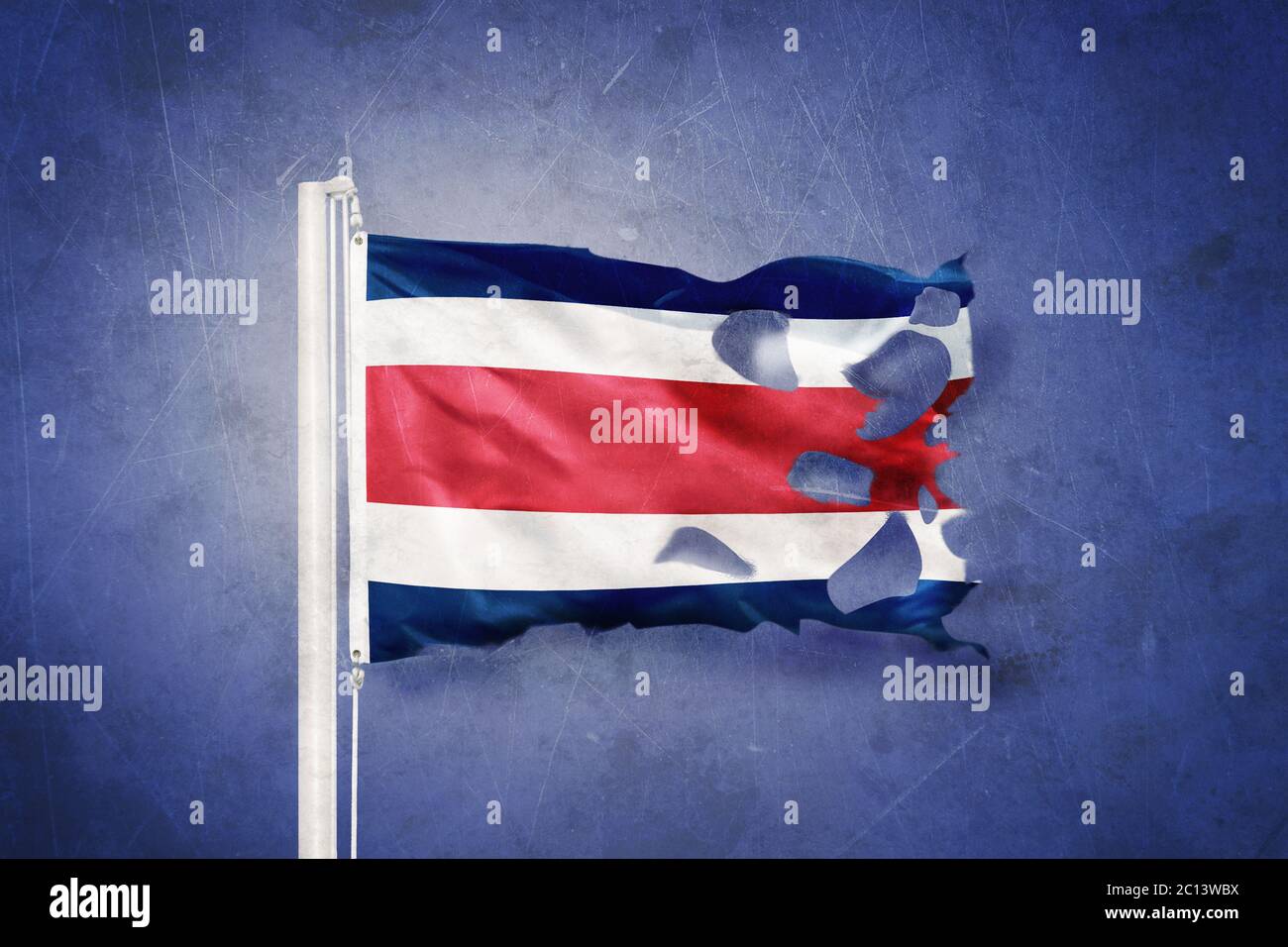 Torn flag of Costa Rica flying against grunge background Stock Photo ...