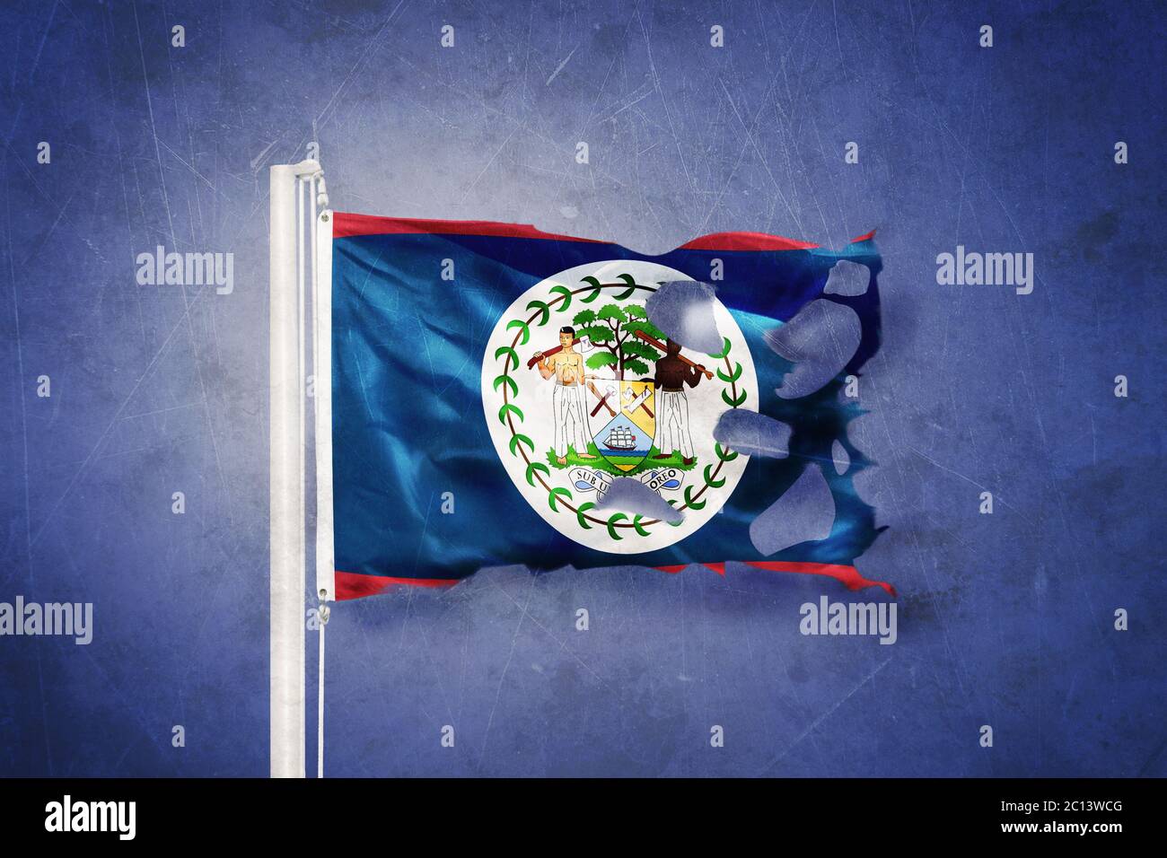 Torn flag of Belize flying against grunge background Stock Photo - Alamy