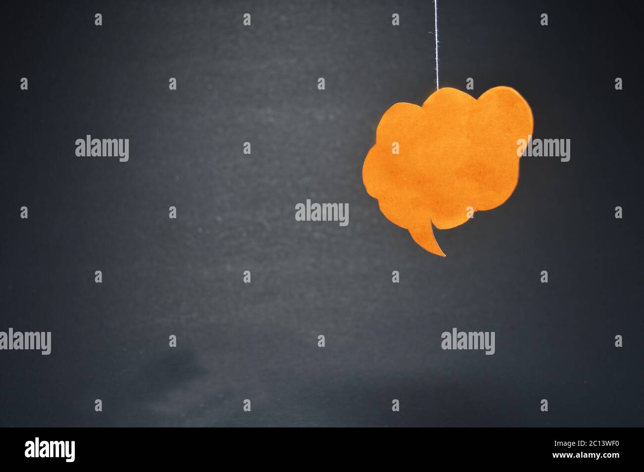 orange call out hanging with some parts in focus against black ...