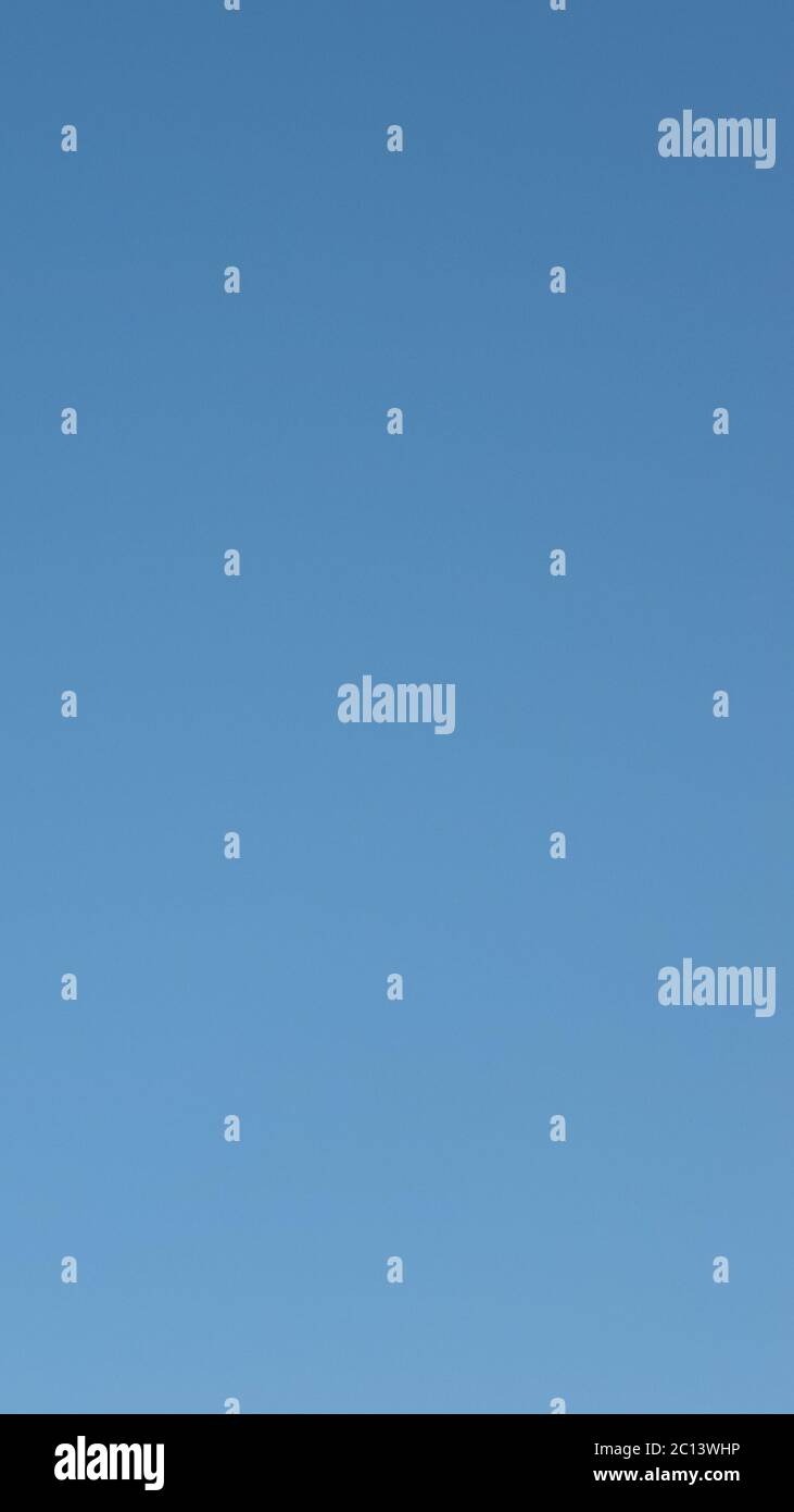Blue sky background - vertical Stock Photo - Alamy