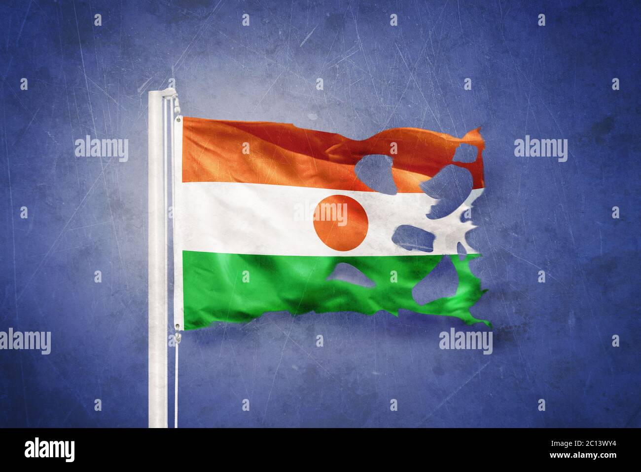 Torn flag of Niger flying against grunge background Stock Photo - Alamy