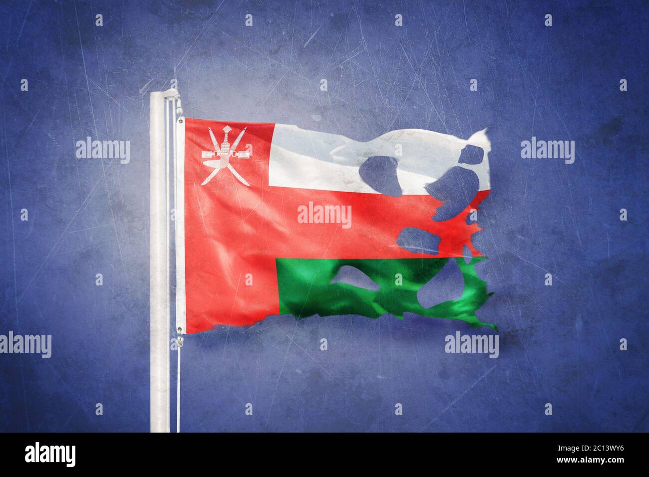 Torn flag of Oman flying against grunge background Stock Photo - Alamy