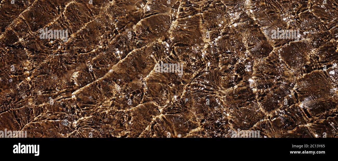 Natural water background. Stream shining in sun at hot summer day ...