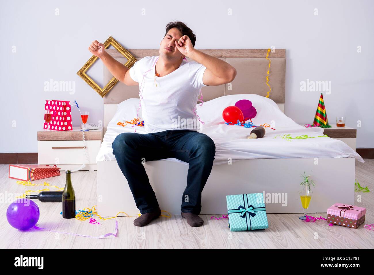 Man at home after heavy partying Stock Photo - Alamy