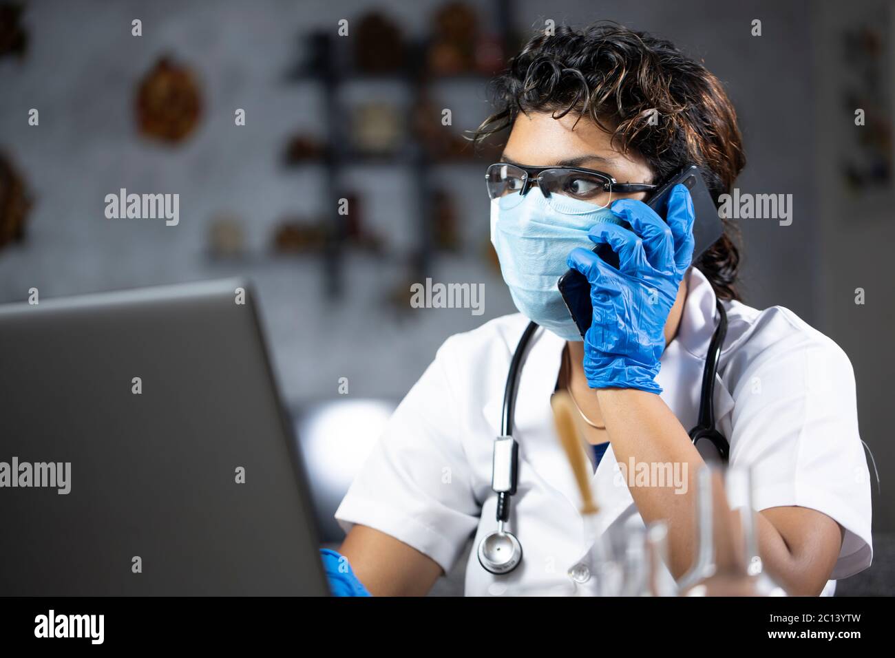 Young female doctor supporting a patient using Mobile phone during lock ...