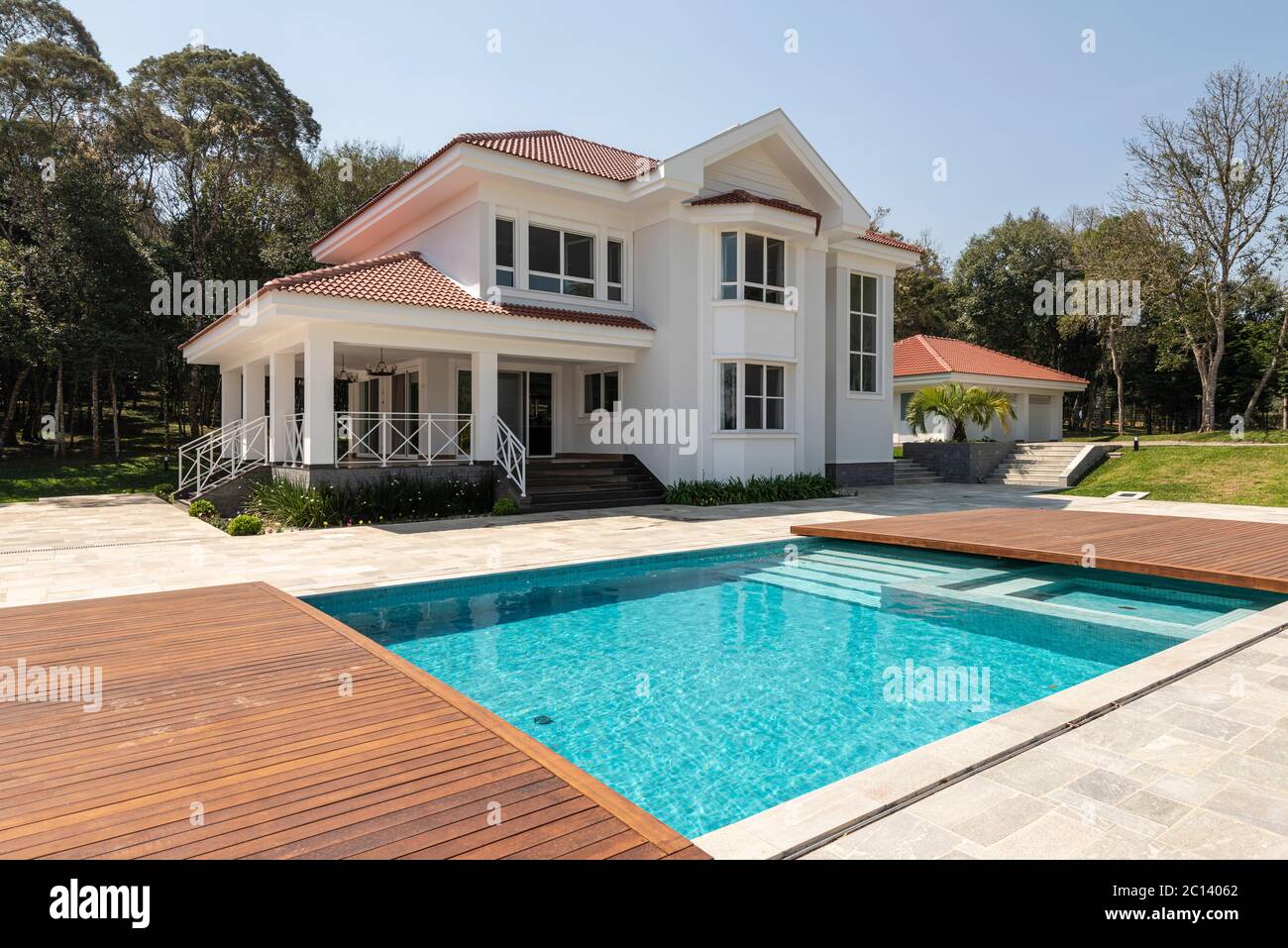 exterior view of a house with swimming pool and moving deck at front ...