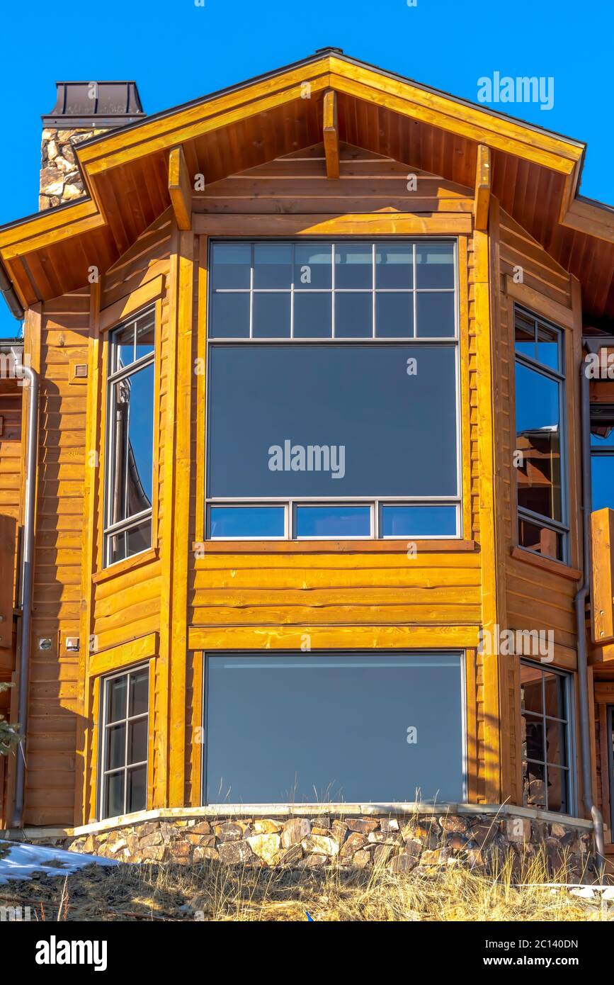 Multi storey home facade with large bay windows and wooden exterior ...