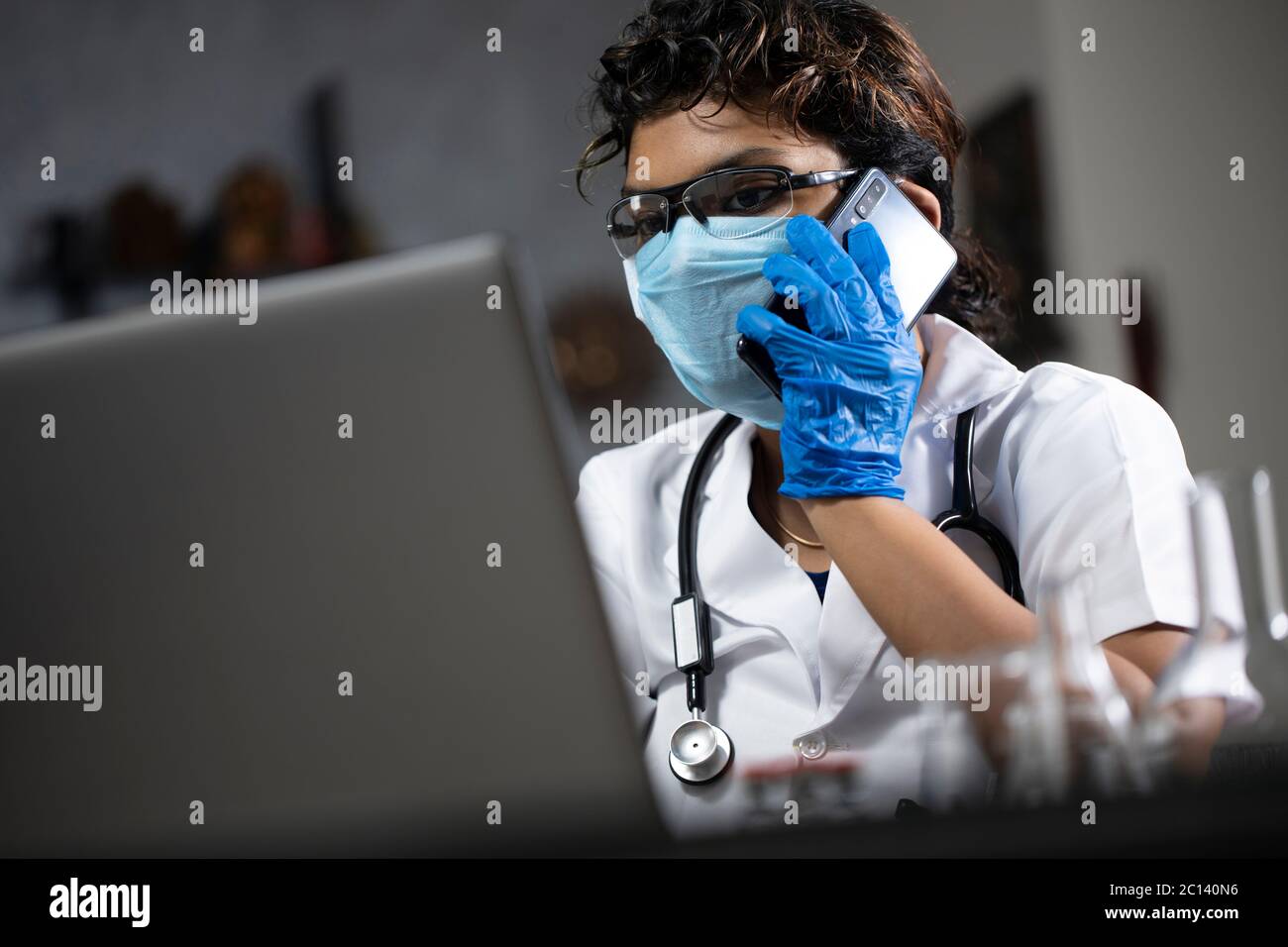 Young female doctor supporting a patient using Mobile phone during lock ...