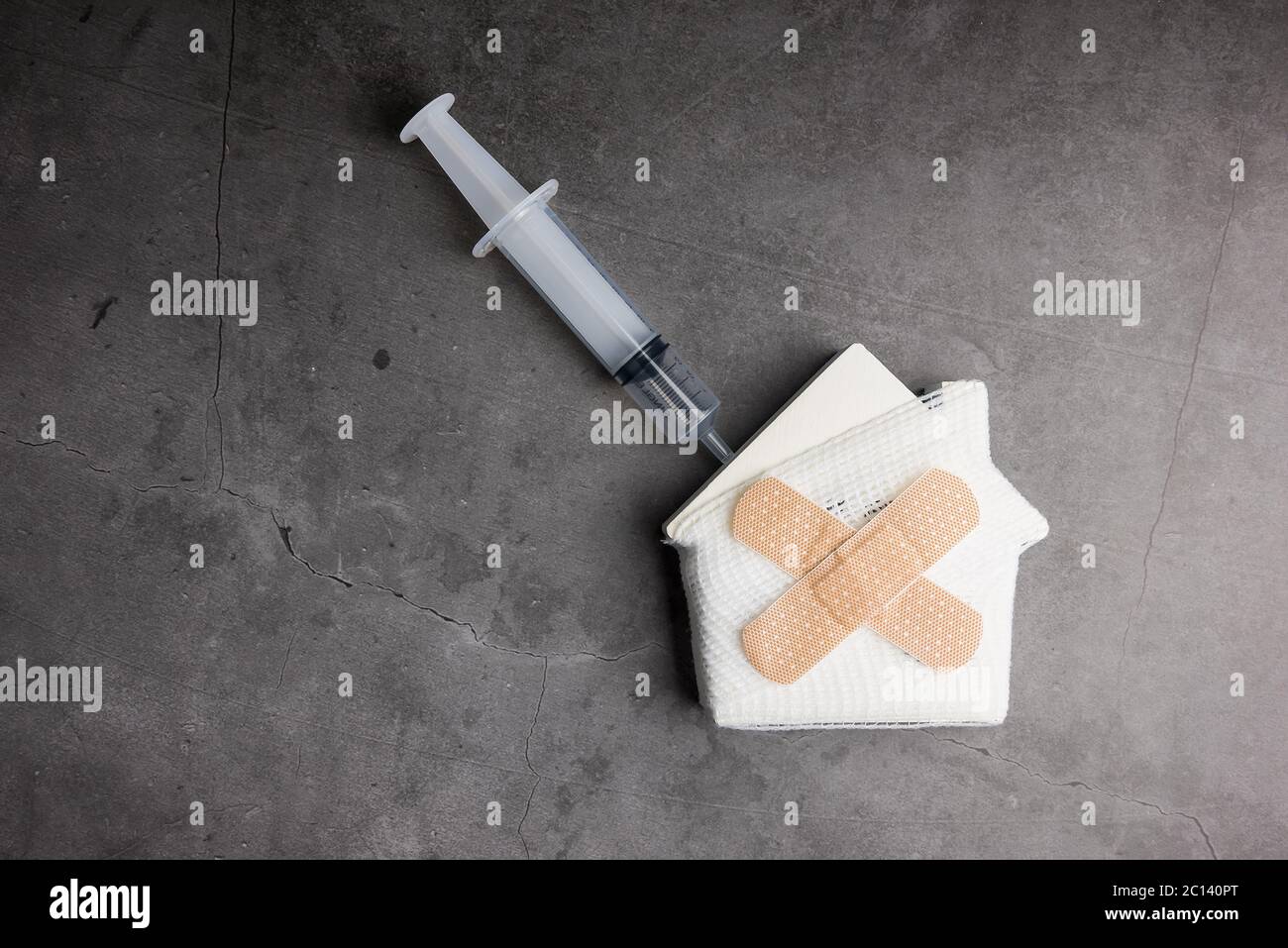 Wooden model white houses and first aid equipment on a cement gray ...