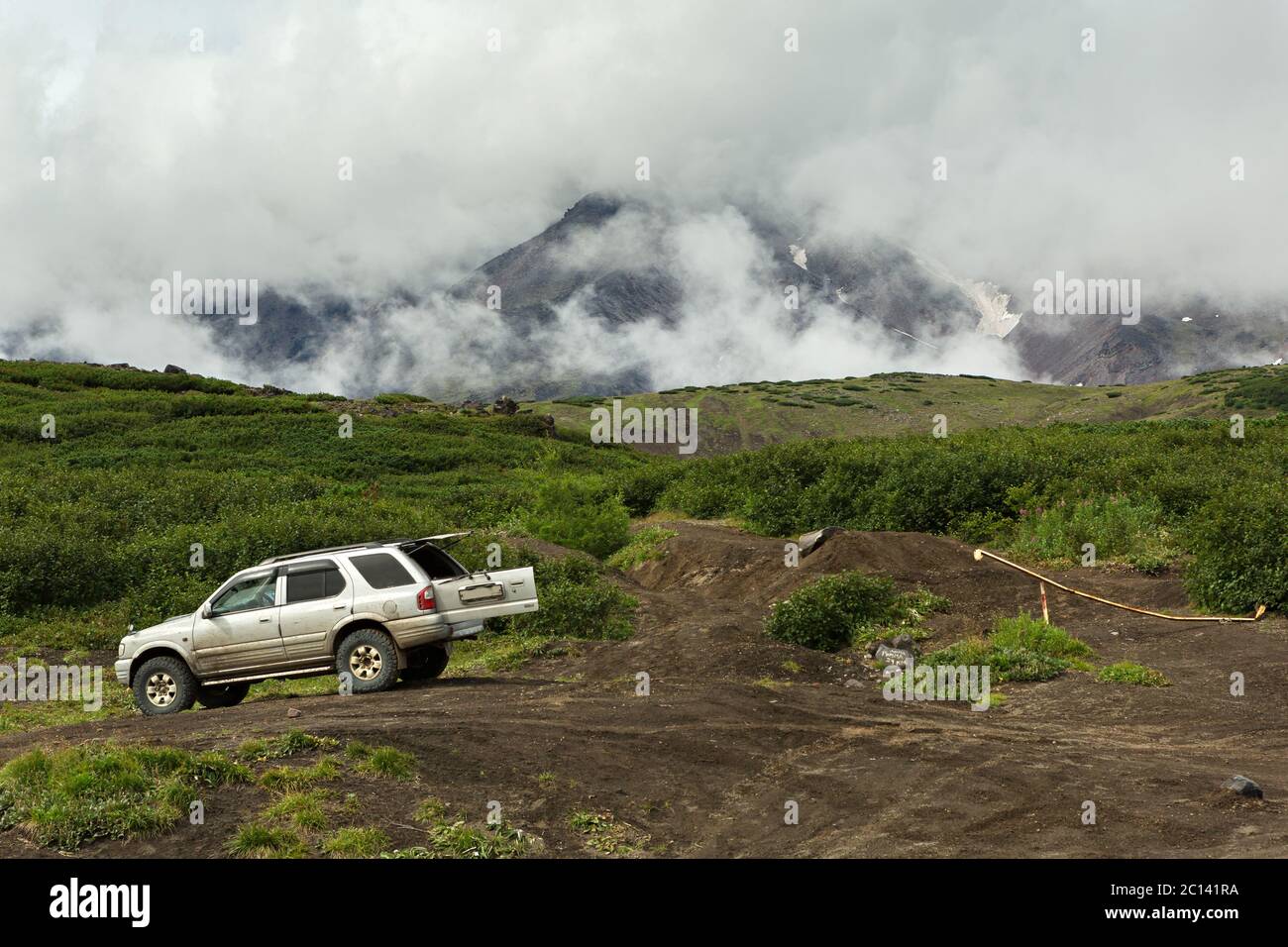 Off-road car on a background of Avacha Volcano or Avachinskaya Sopka on ...