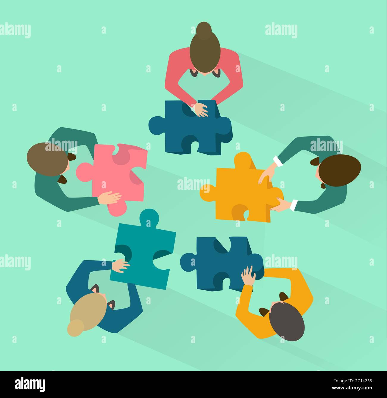 Teamwork and collaboration. Overhead view of company staff with puzzle ...