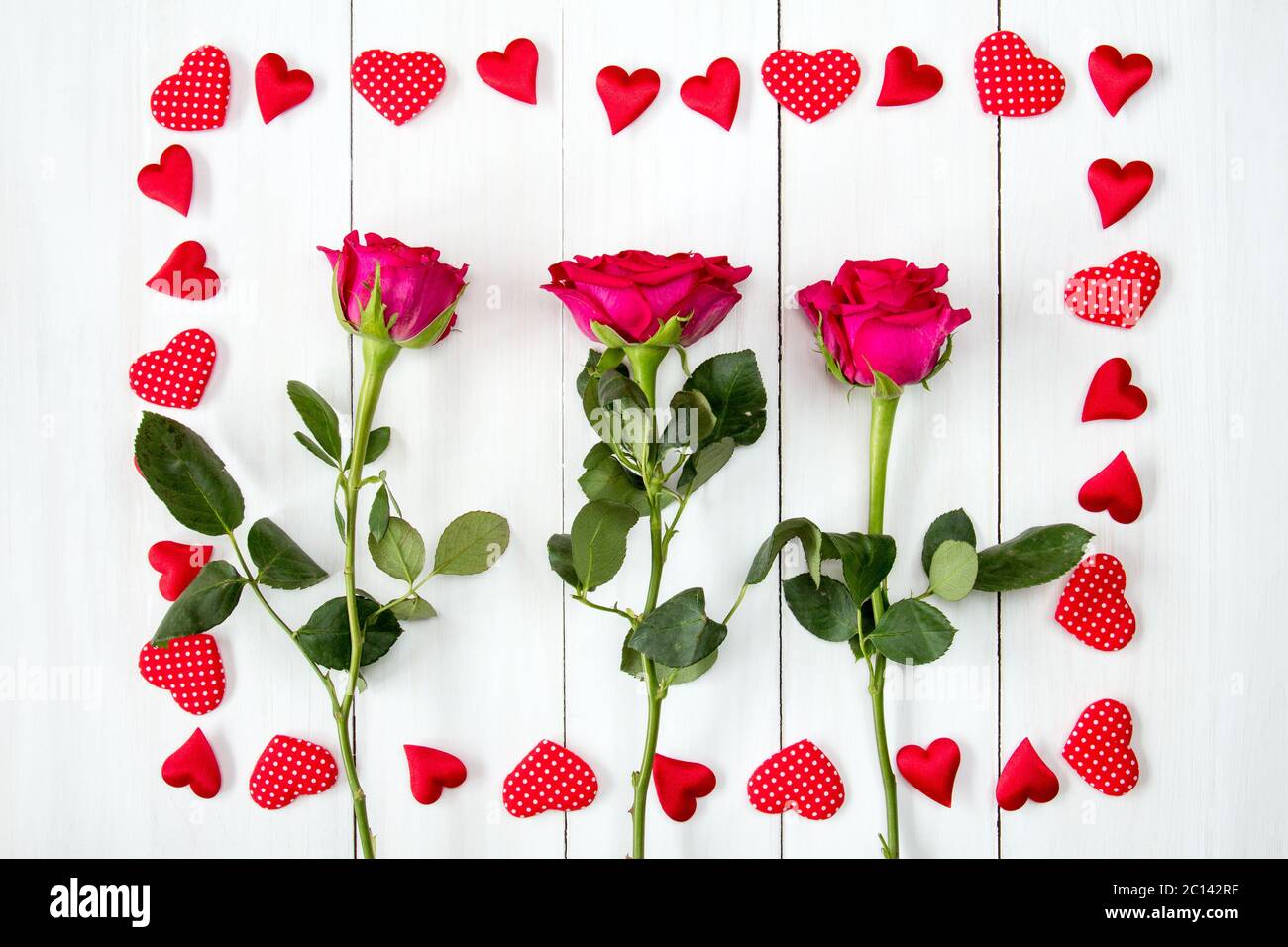 Three roses with frame from hearts Stock Photo - Alamy