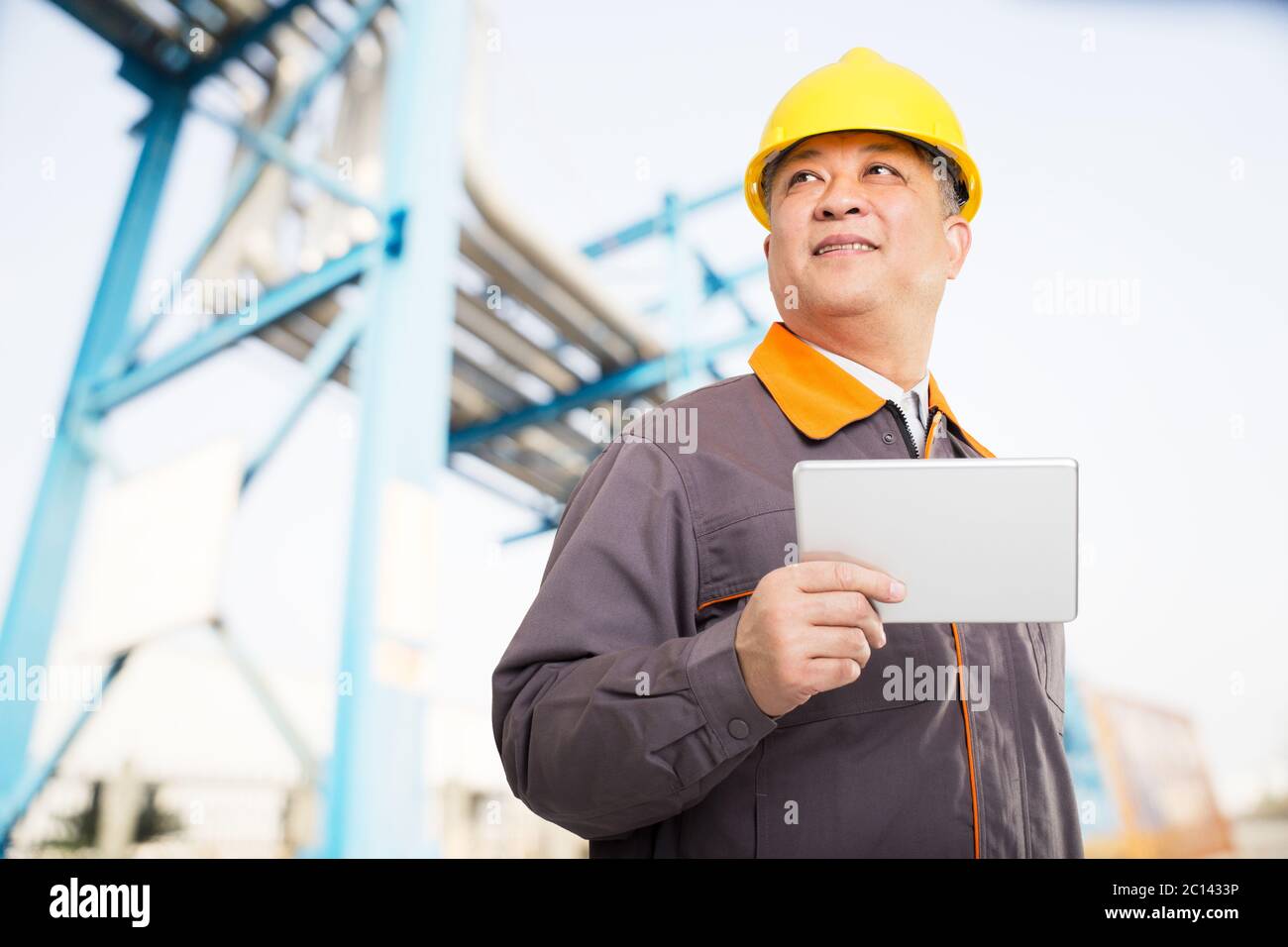 old chinese man engineer in oil refinery plant Stock Photo - Alamy