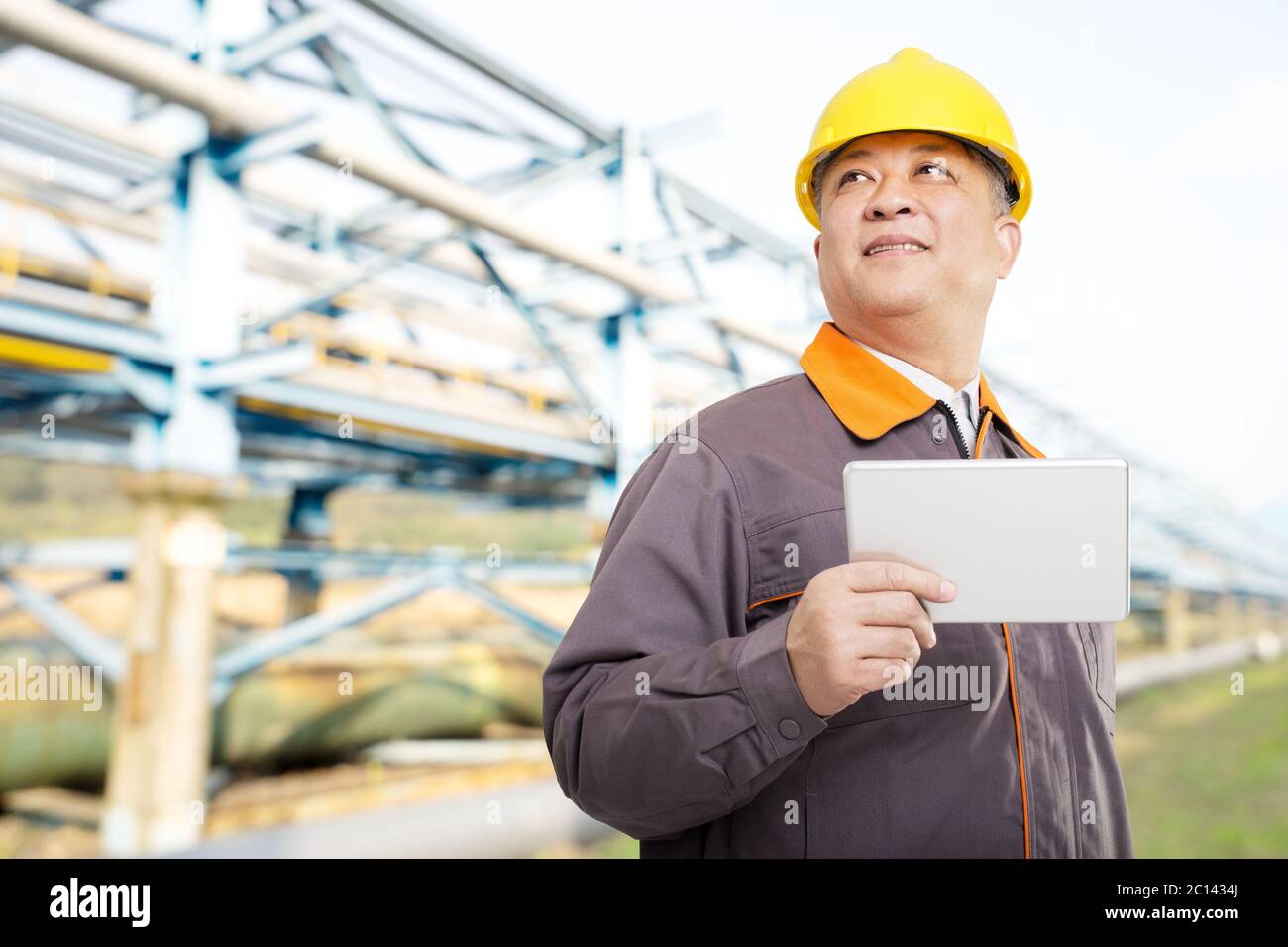 old chinese man engineer in oil refinery plant Stock Photo - Alamy