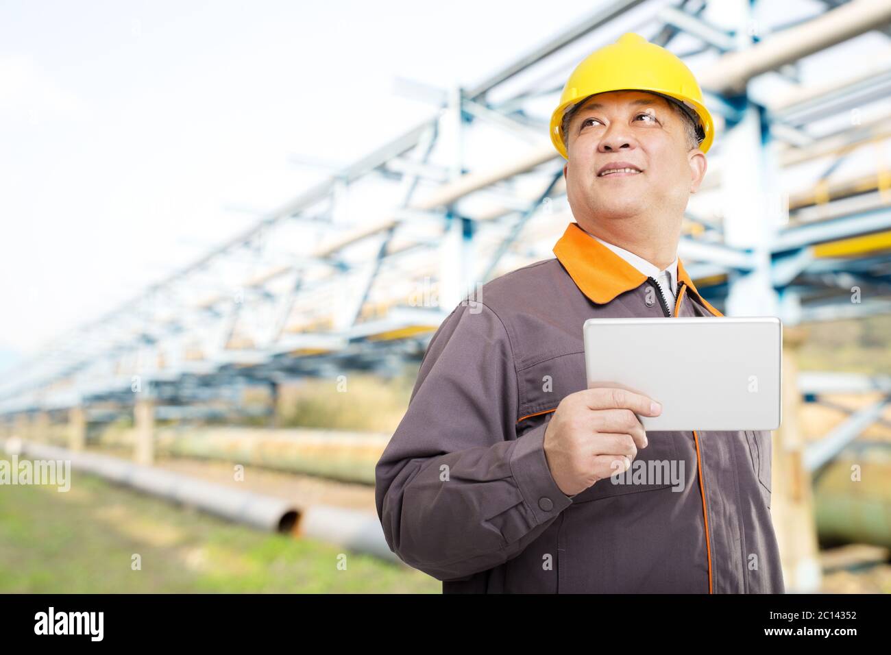 old chinese man engineer in oil refinery plant Stock Photo - Alamy