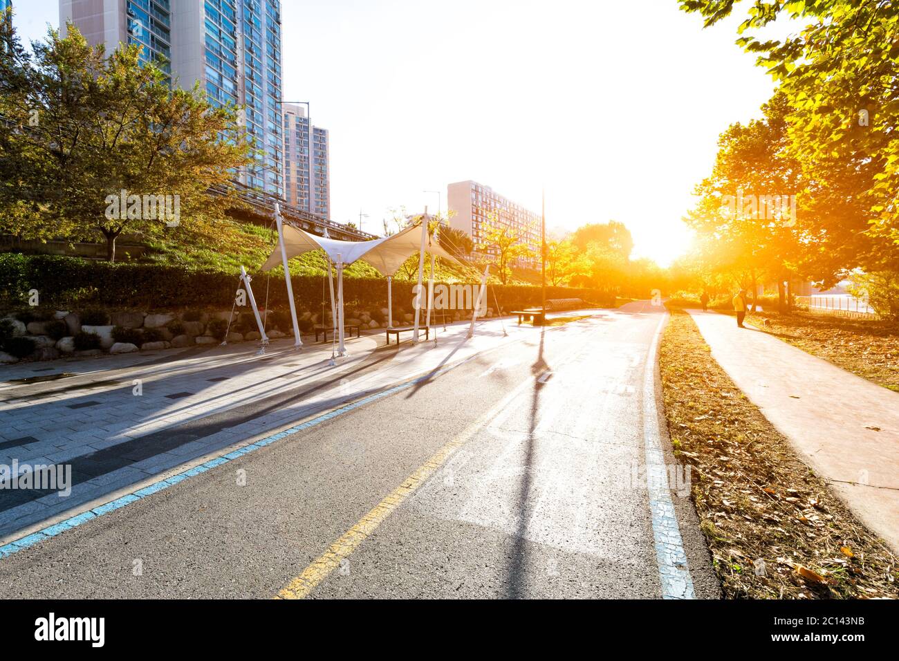 traffic on road in midtown of modern city at sunrise Stock Photo - Alamy