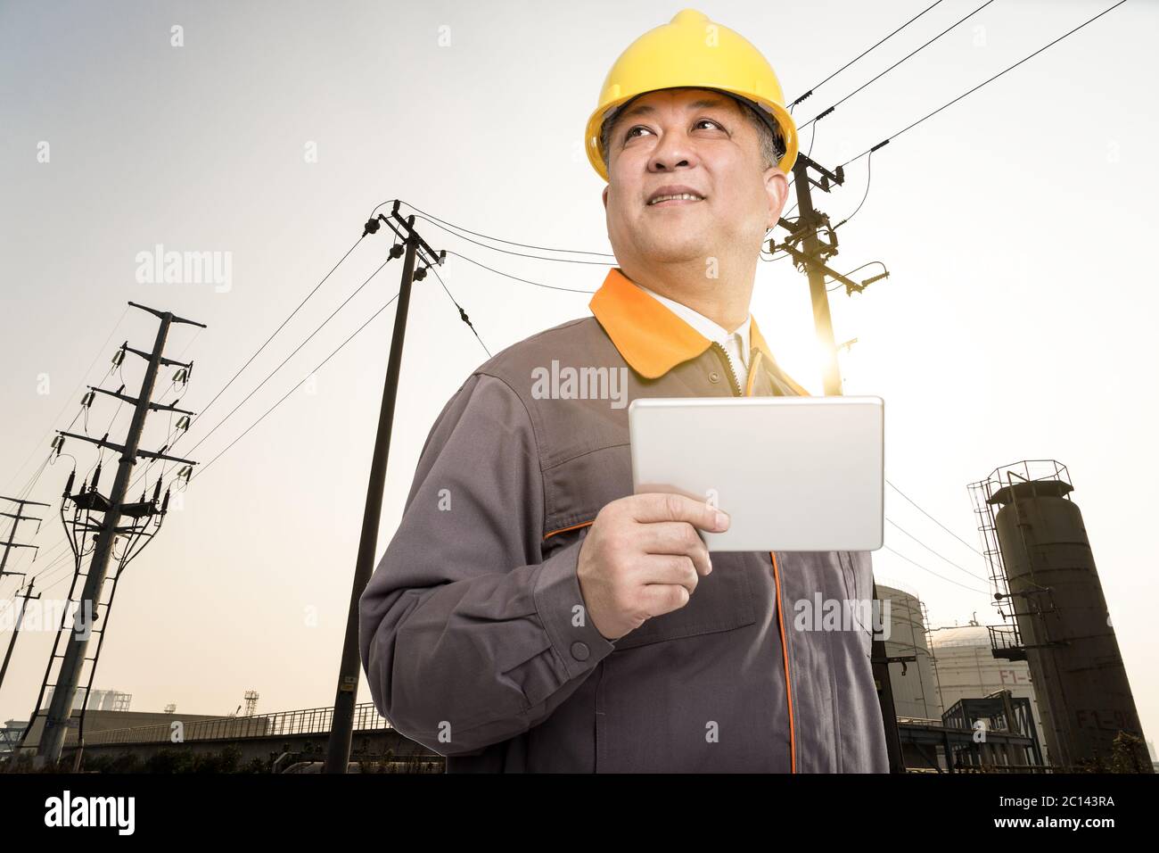 old chinese man engineer in oil refinery plant Stock Photo - Alamy