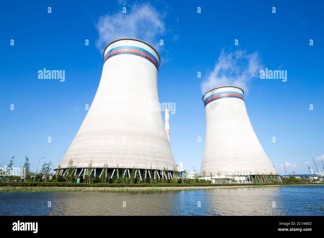 modern power plant near river in blue sky Stock Photo - Alamy