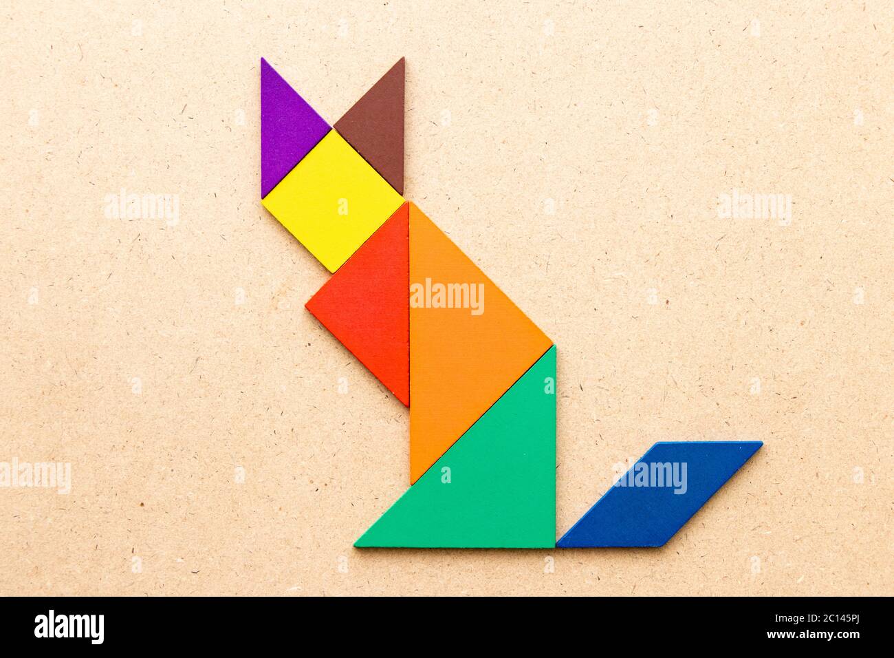 Color tangram puzzle in cat shape on wood background Stock Photo - Alamy