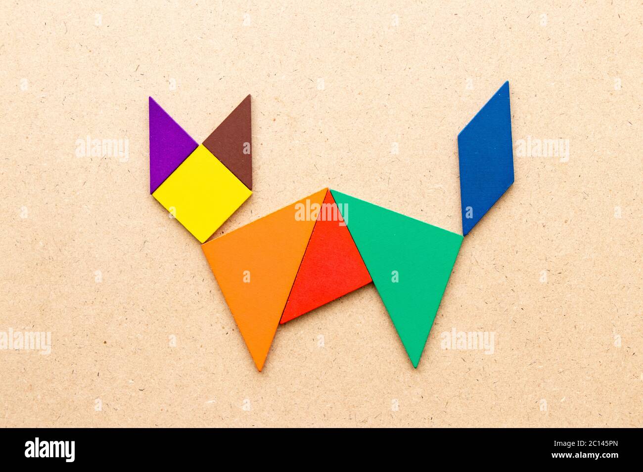 Color tangram puzzle in cat shape on wood background Stock Photo - Alamy