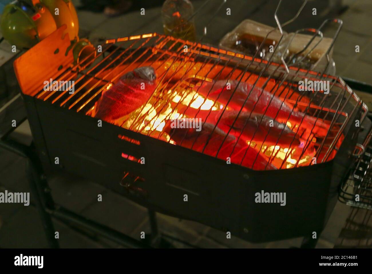 Fish being grilled on coal fired barbecue in Bali at night Stock Photo ...