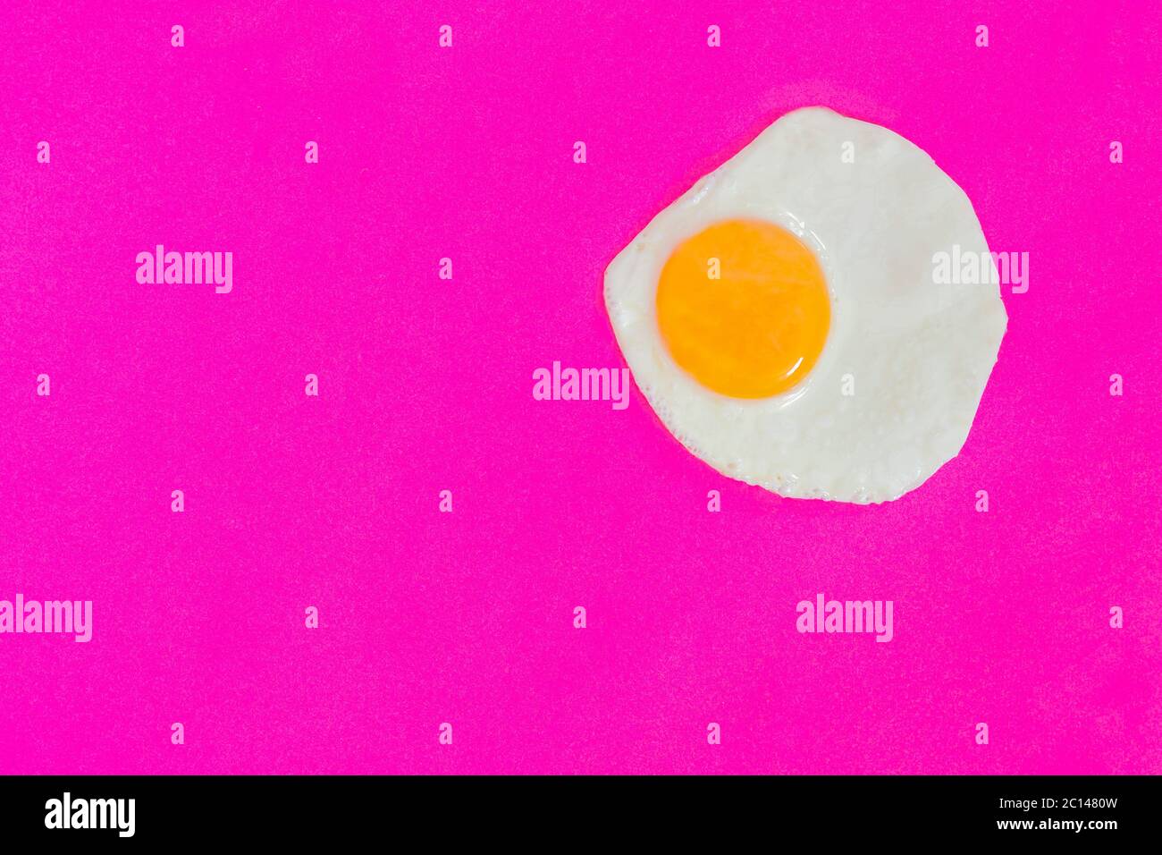 A fried egg on pink background, pop art, isolated, minimal Stock Photo ...