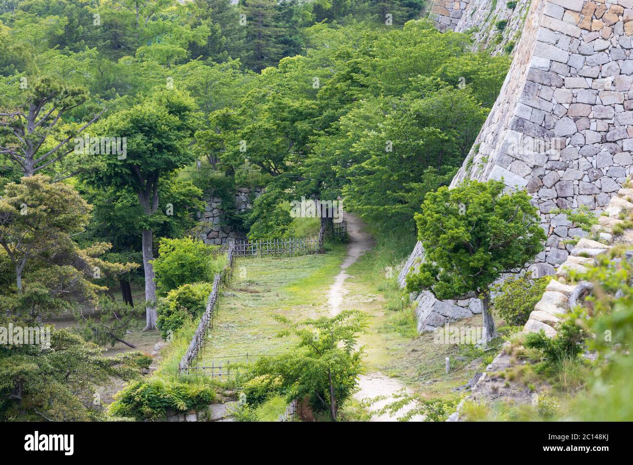 Narrow dirt path under ancient stone walls of Akashi Castle Stock Photo ...