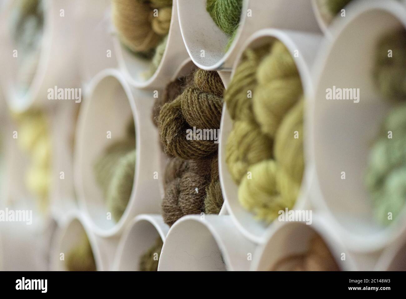 colorful wool yarn storage inside plastic pipes Stock Photo - Alamy