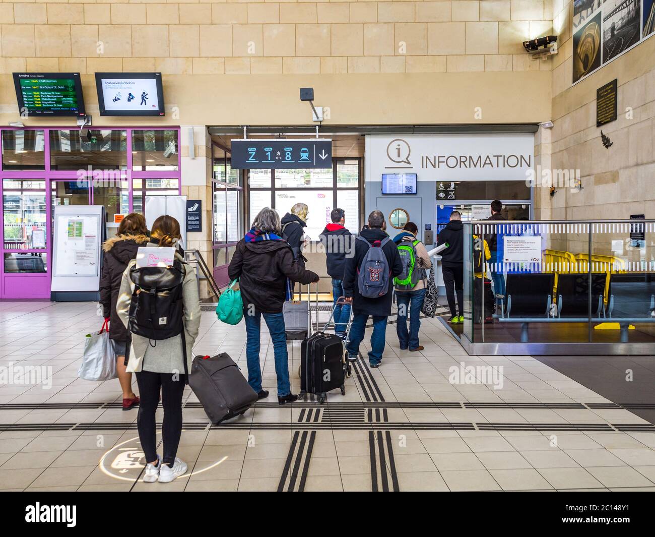 Travellers inside booking / waiting hall of Poitiers SNCF station ...