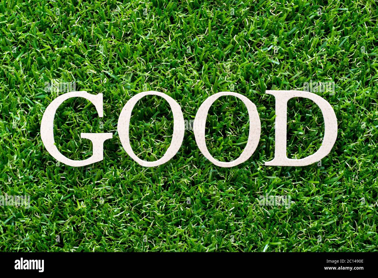 Wood letter in word good on artificial green grass background Stock ...