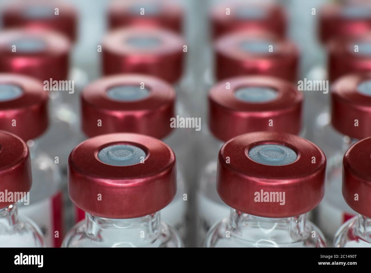 Close-up of Glass medicine bottles with injection fluid with red ...