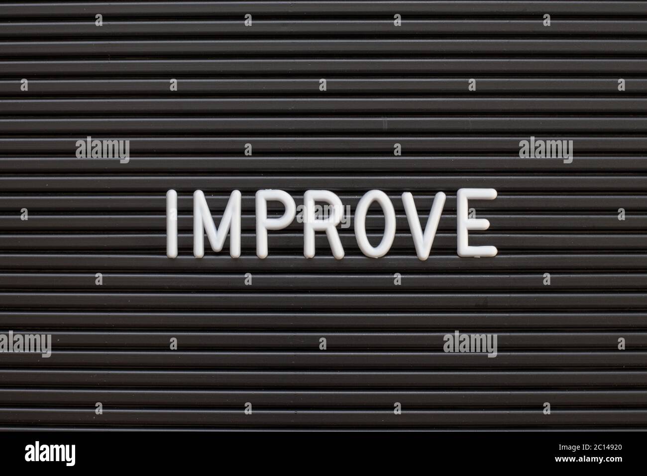 Black color felt letter board with white alphabet in word improve ...