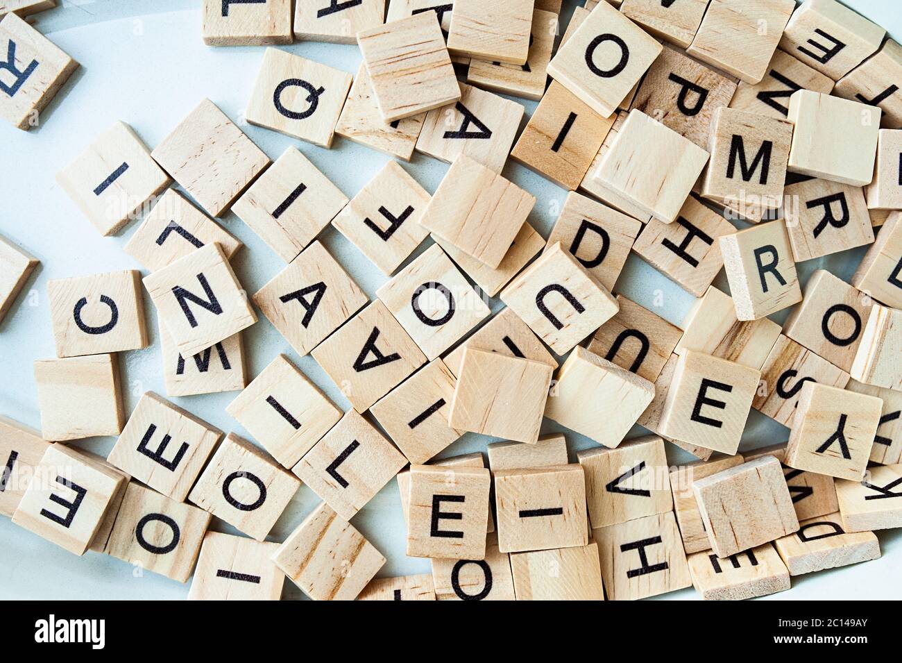 many identical wooden and square letters on a light background Stock ...