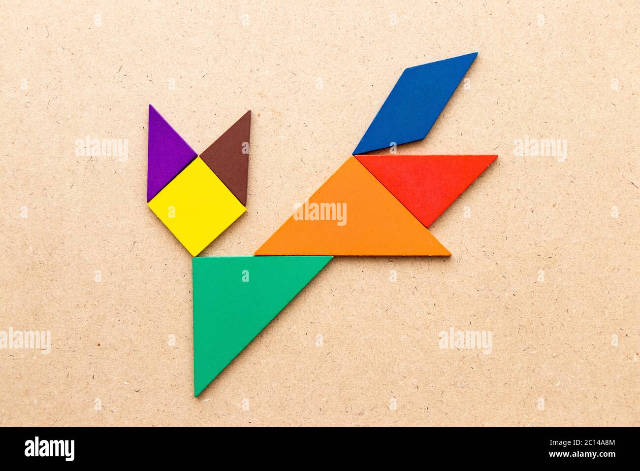 Color tangram running cat or fox puzzle in shape on wood background ...