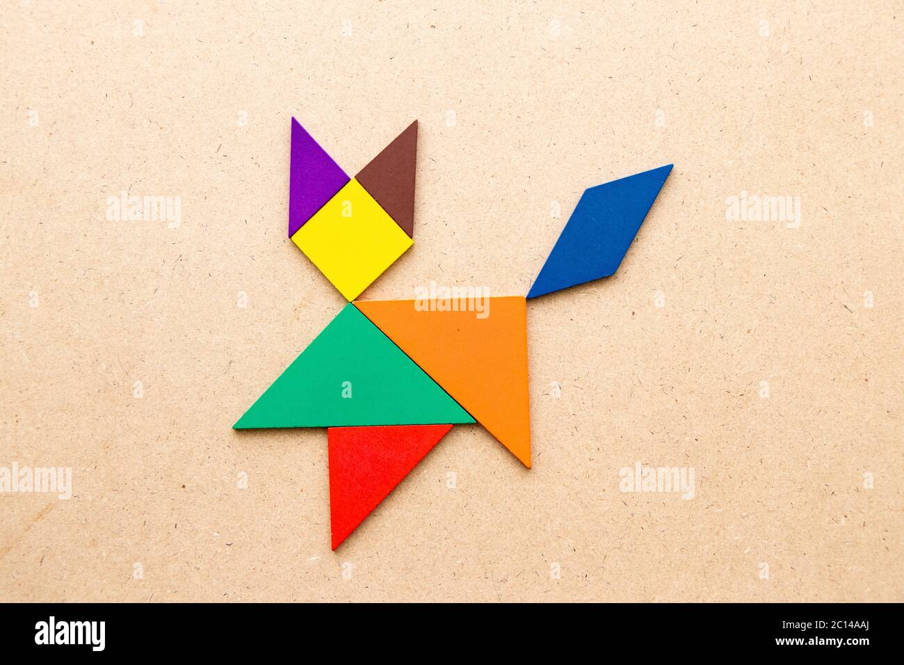 Color tangram puzzle in cat shape on wood background Stock Photo - Alamy