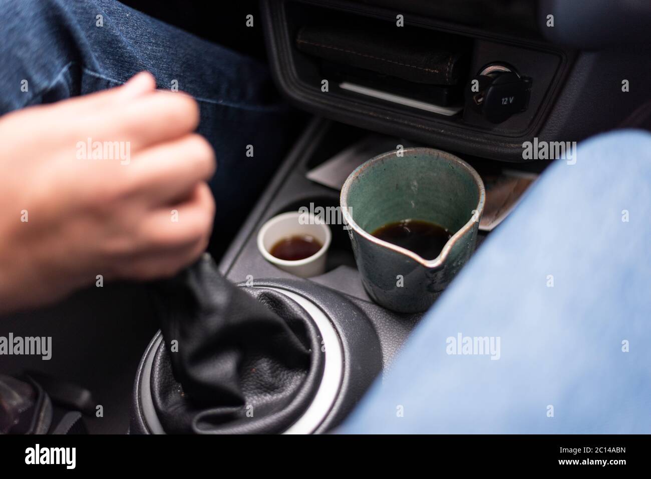 coffee cups brewed inside a car on dashboard with beautiful light and ...
