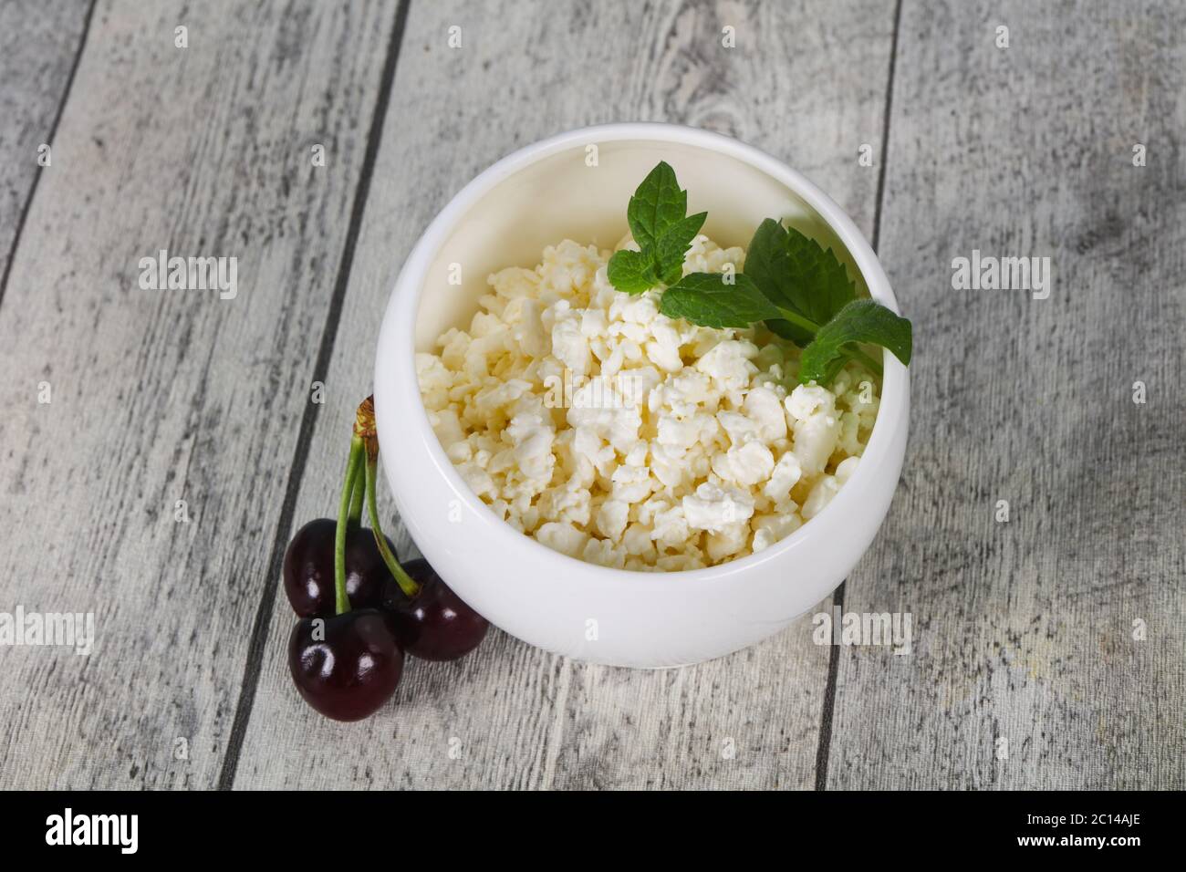 Fresh tasty curd in the bowl served mint and cherry Stock Photo - Alamy