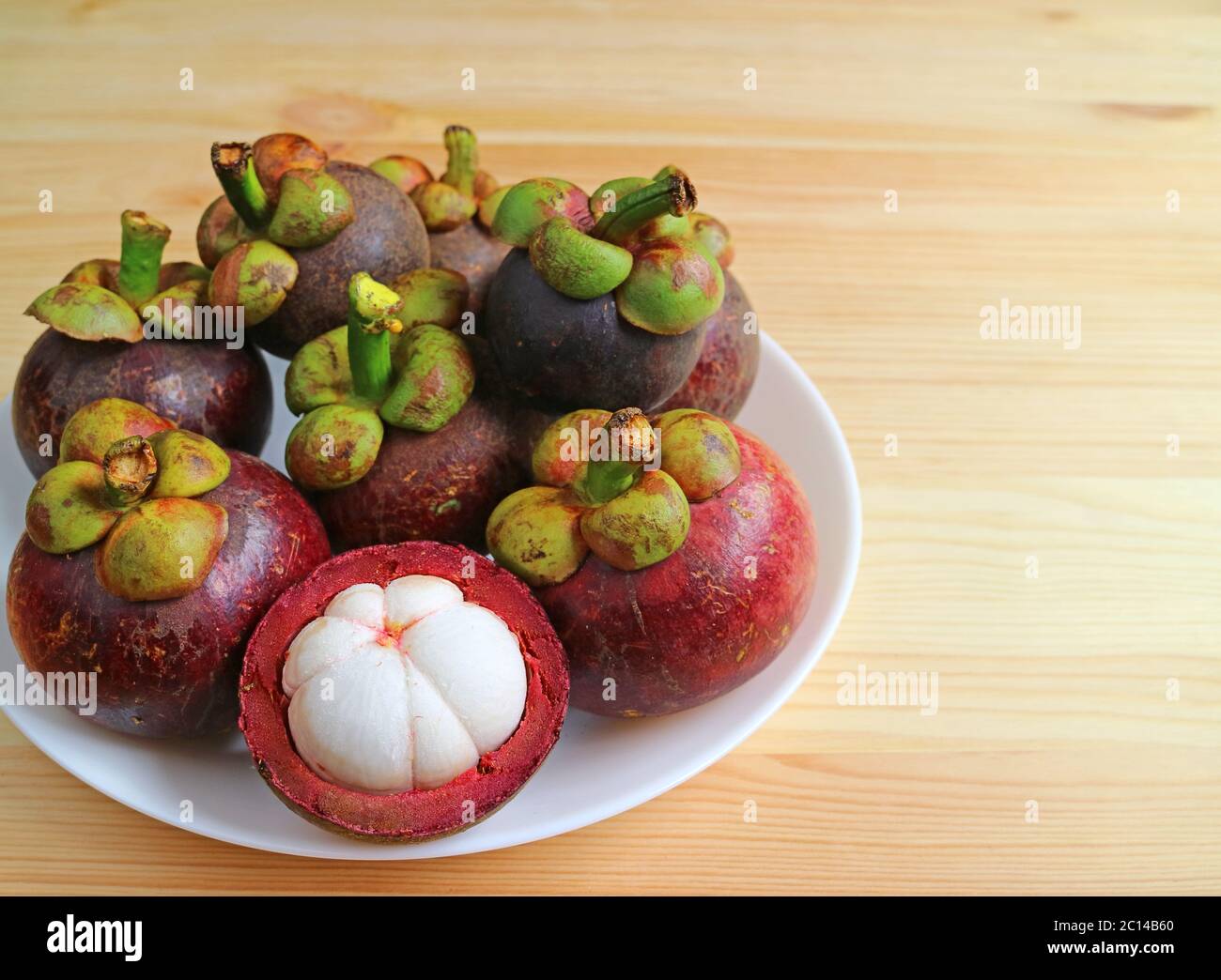 Plate of Ripe Mangosteen Whole Fruits with One Cut in Half Isolated on ...