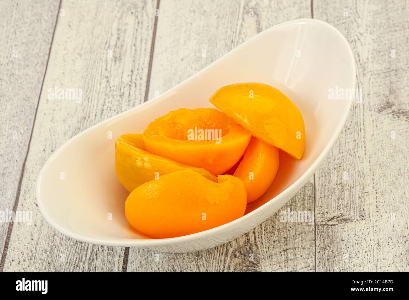 Marinated peaches fruit in the bowl with syrope Stock Photo - Alamy