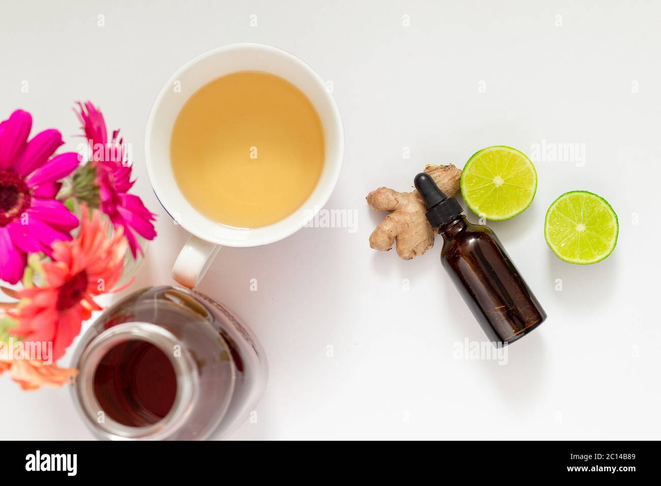 Top shot, cup of tea with a bottle of ginger drops and lemon wedge ...