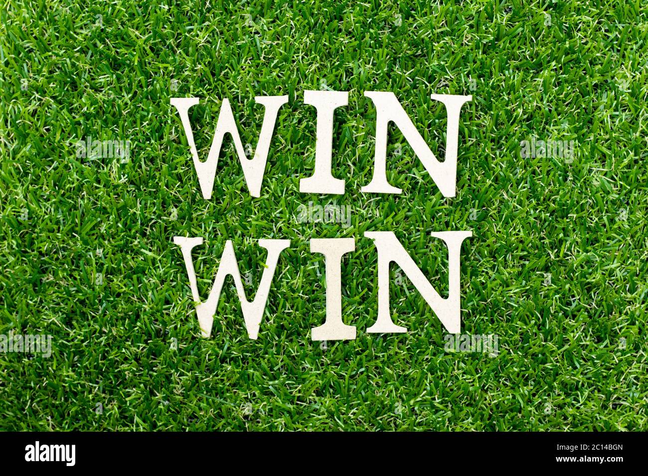 Wood alphabet letter in word win win on green grass background Stock ...